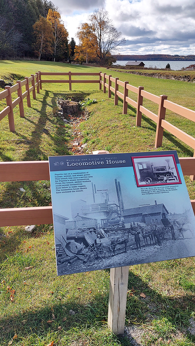 A simple fence marks where the locomotive house once stood, the ghostly footprint of industrial power that once drove this bustling community.