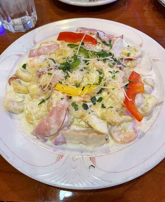 The Amante Di Luna combines chicken, shrimp, and prosciutto like they're the Avengers of Italian cuisine, saving dinner one bite at a time.