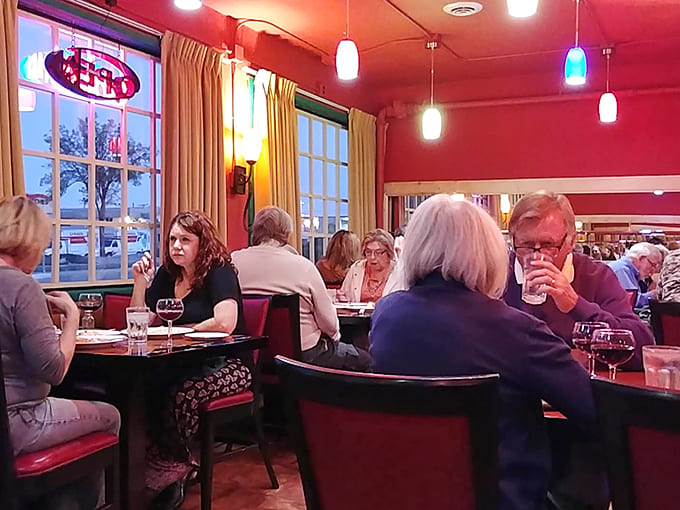 Happy diners sharing meals and moments prove that the best ingredient in any restaurant is the warmth of people enjoying good food together.