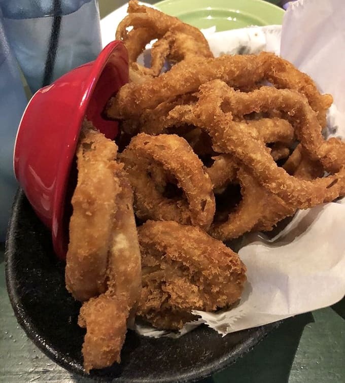 Those golden onion rings are so perfectly crispy they could double as edible jewelry, delicious, crunchy bracelets.