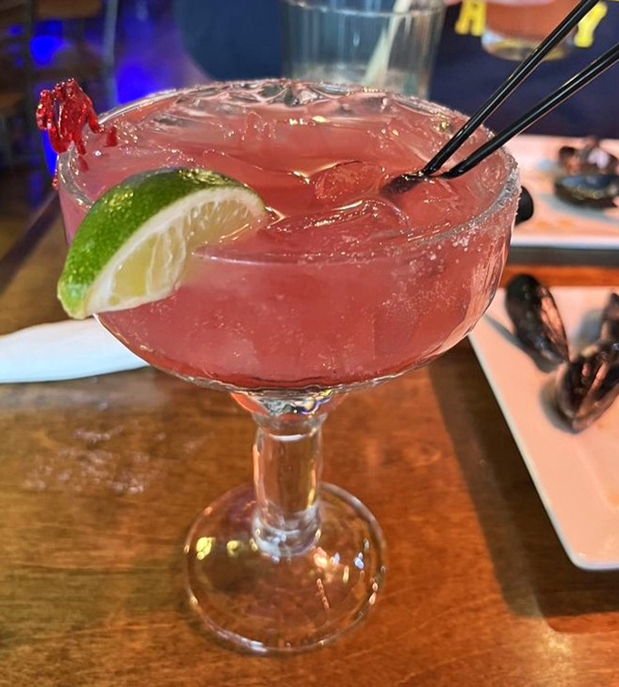 Ruby-red liquid sunshine with a lime crown&mdash;this cocktail doesn't just complement seafood; it throws a beachside party for your taste buds.