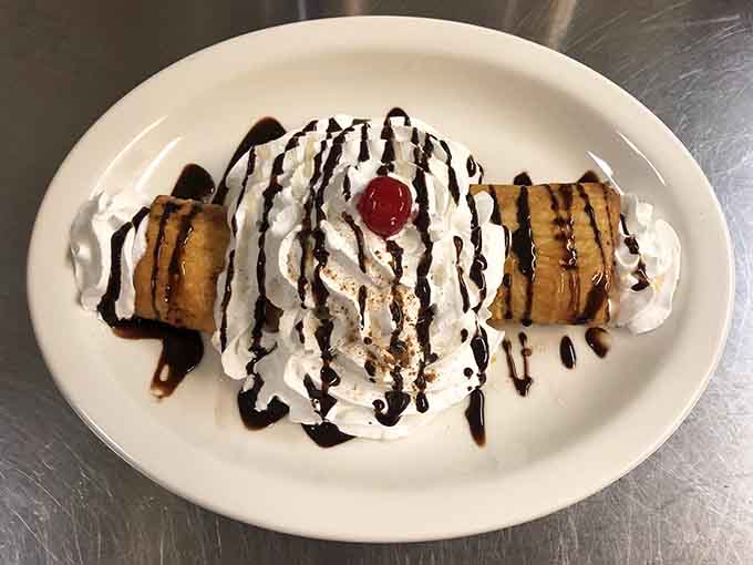 Fried ice cream arrives as a glorious contradiction, drizzled with chocolate and topped with whipped cream, because apparently they want you to be completely happy.