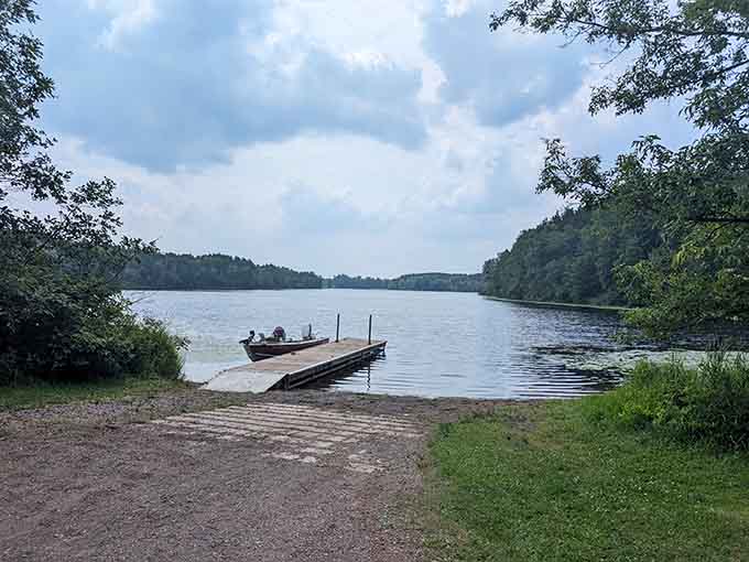 The boat dock extends into calm waters, offering front-row seats to Echo Lake's daily performance of peace.