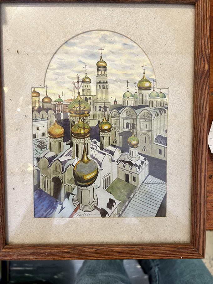 This painting of Moscow's Kremlin captures the golden domes and architectural splendor of a bygone era, no passport required.