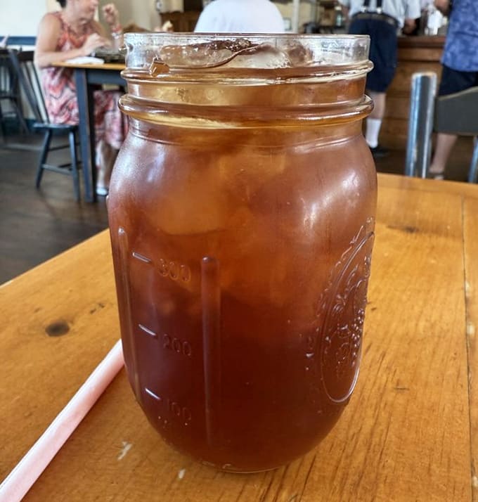 Sweet tea in a mason jar is the official beverage of "I'm staying awhile," perfectly sweetened and endlessly refillable for proper Southern hospitality.