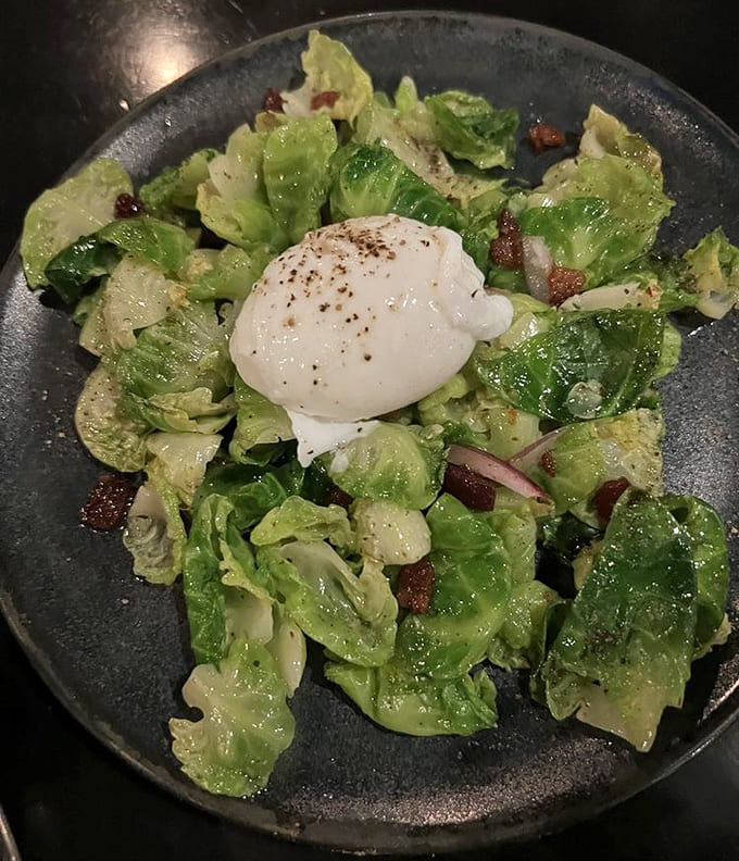 Even the salads here get the star treatment, with fresh greens and a perfectly poached egg creating simple elegance on a plate.