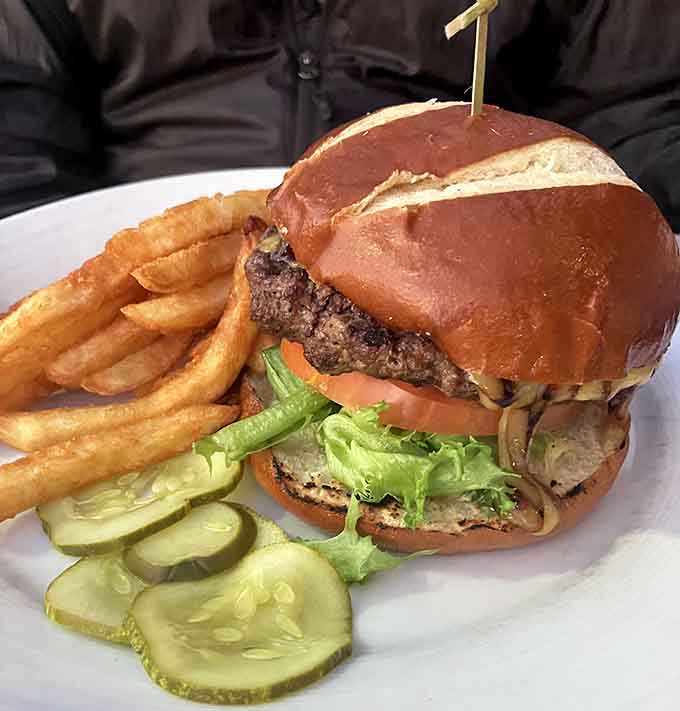This burger means business, stacked high with all the fixings and sided by fries that could convert even the most devoted salad enthusiast.
