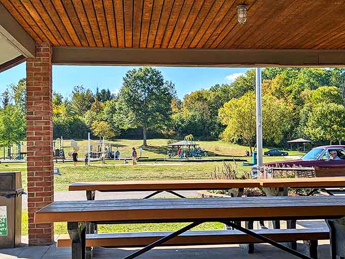 Picnic tables waiting patiently under shelter &ndash; silent witnesses to countless family gatherings, first dates, and impromptu lunches.