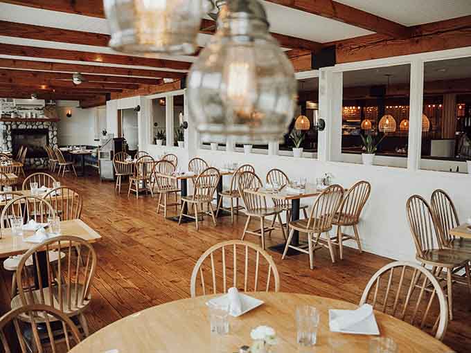 The main dining room features Windsor chairs and harbor views, creating a space that feels both classic and contemporary.