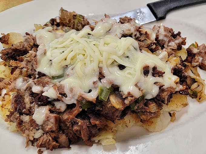 Tender beef smothered in mushrooms and gravy atop a bed of home fries &ndash; comfort food that hugs you from the inside.