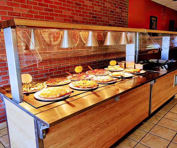 The buffet station stands ready like an all-you-can-eat altar to pizza perfection, constantly refreshed and always tempting.