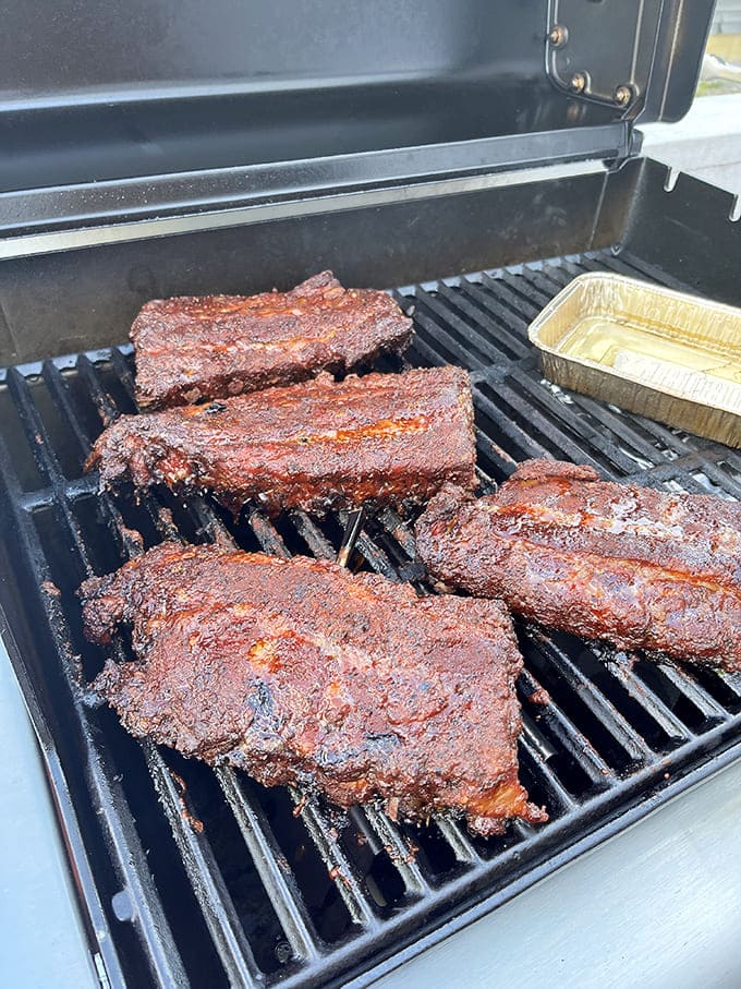 Barbecue perfection on the grill. That mahogany bark holds secrets only slow smoking and patience can reveal.