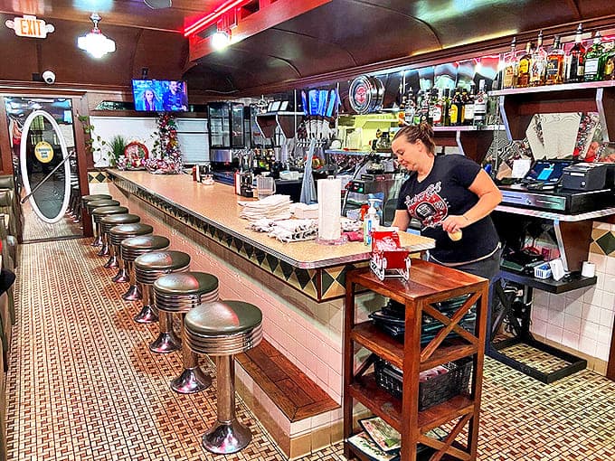 The counter where magic happens &ndash; classic bar stools invite you to sit and watch the choreographed dance of short-order cooking.