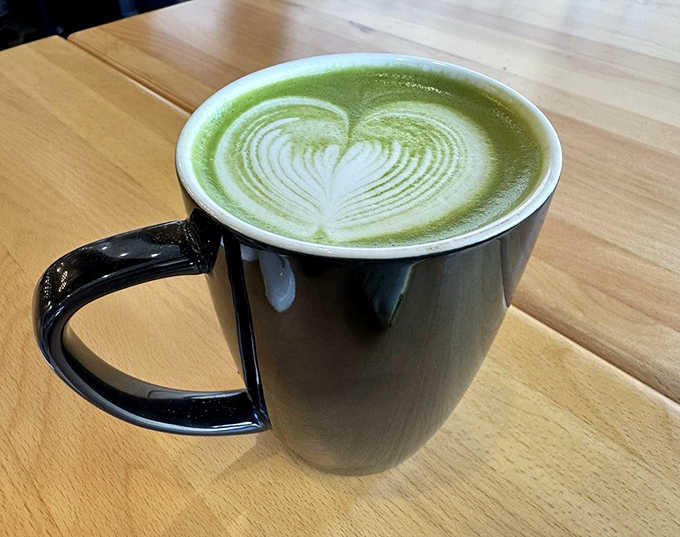 The vibrant green matcha latte offers a moment of zen amid the bustling caf&eacute; &ndash; its heart-shaped foam art adding a touch of whimsy.