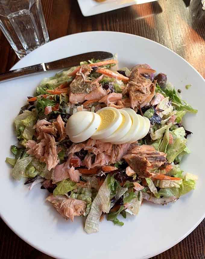 Salmon chopped salad proving this kitchen can handle savory dishes with the same skill they bring to sweet creations.