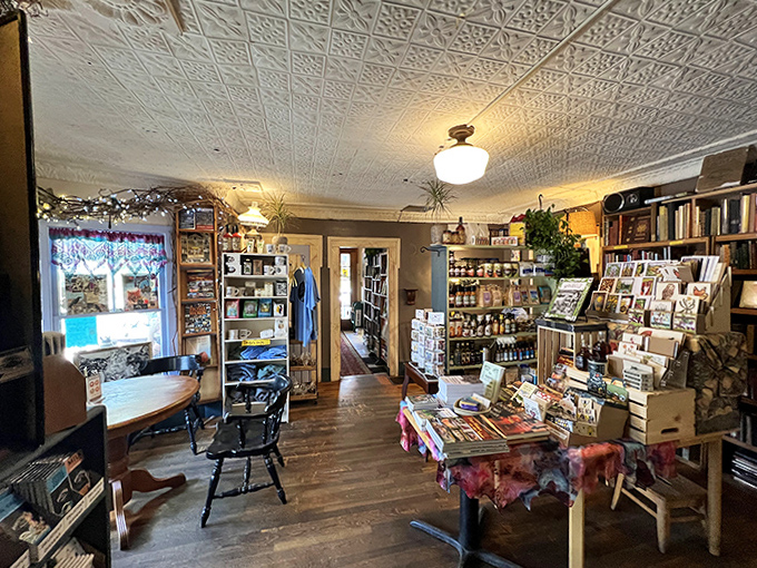 Mismatched tables and chairs create an inviting atmosphere where coffee, conversation, and contemplation blend seamlessly under pressed-tin ceilings.