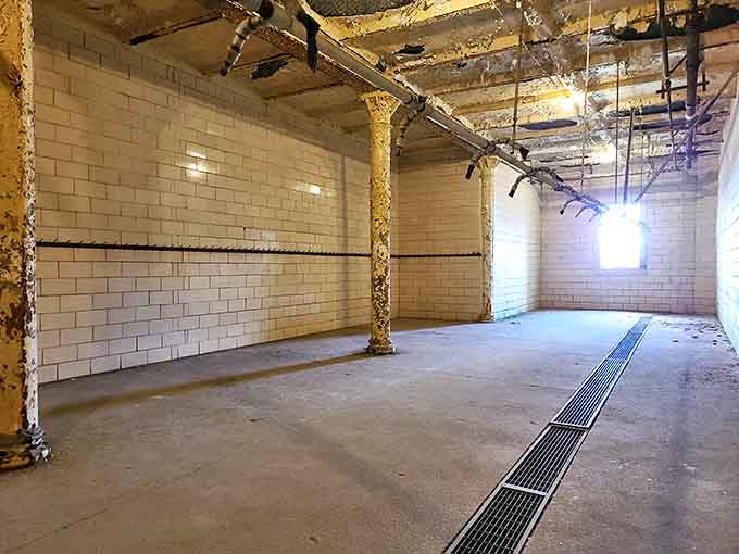 Shower Room: Institutional tile and exposed plumbing create a space where vulnerability was unavoidable and dignity was a luxury.