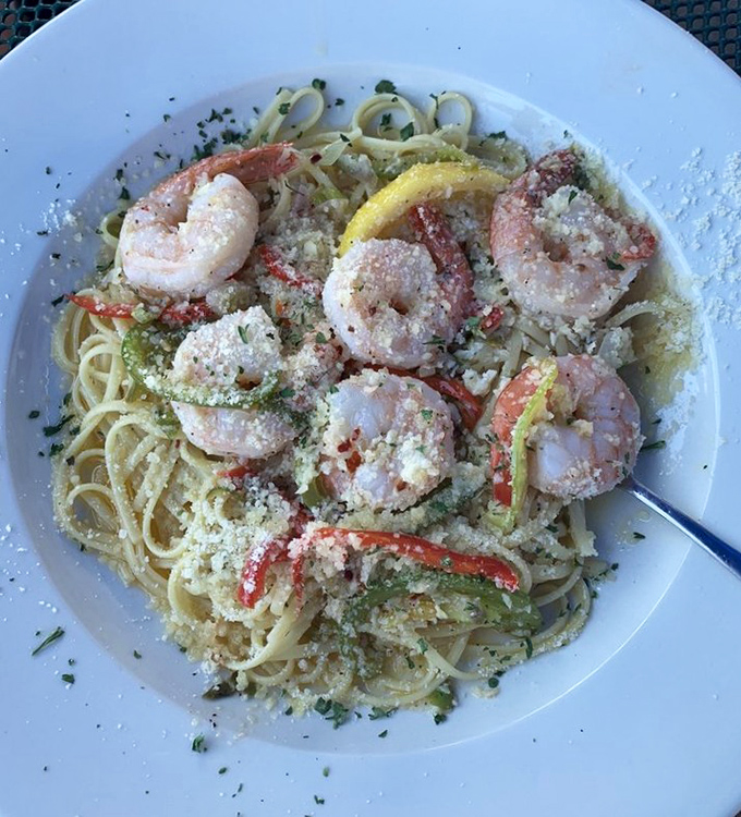 Plump shrimp nestled among pasta strands, glistening with garlic and herbs &ndash; J's scampi proves seafood and pasta are soulmates meant to be together.
