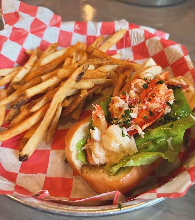This lobster roll is stuffed so generously that it barely fits in the bun, like someone in the kitchen forgot how to count and we're all better for it.