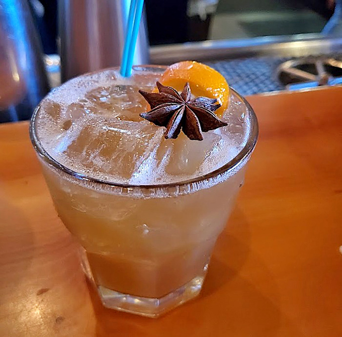 A craft cocktail garnished with star anise and citrus &ndash; because even your drink deserves to be dressed for the occasion.