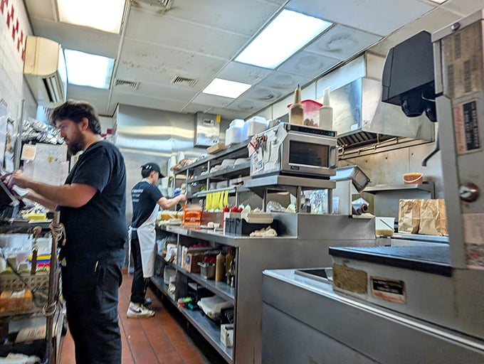 Behind the scenes, sandwich architects work their magic, transforming simple ingredients into towering monuments to Jewish culinary tradition.