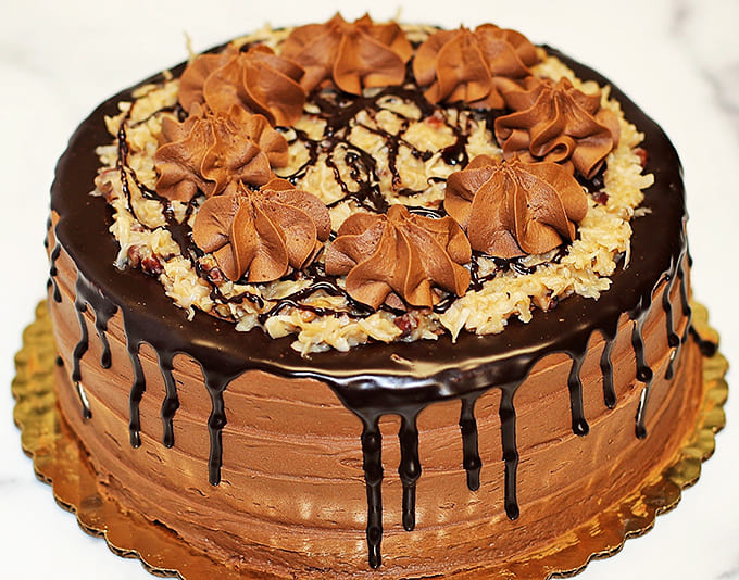 This cake means business with its chocolate frosting rosettes and drizzle work that would make any celebration instantly better.