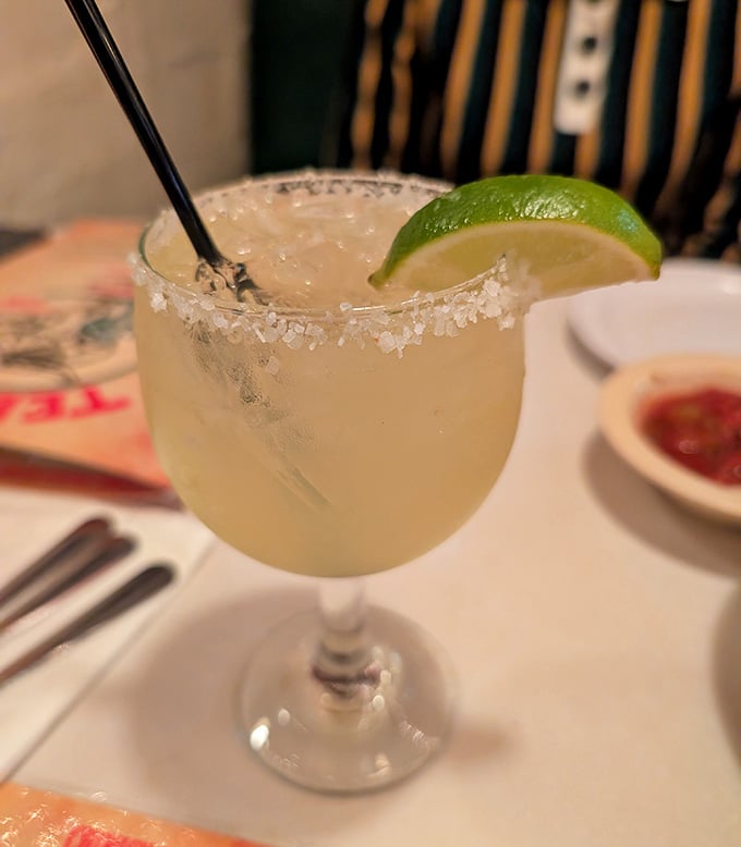 That salt-rimmed margarita promises the perfect balance of tart and sweet, your liquid companion for the cheesy adventure ahead.