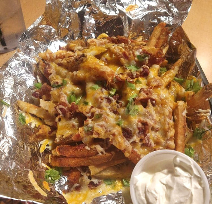 Loaded fries buried under queso and bacon represent everything beautiful about American bar food done absolutely right.