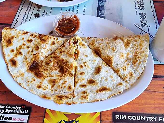 A quesadilla that actually fills the plate, proving that lunch items receive the same supersized love as breakfast offerings.