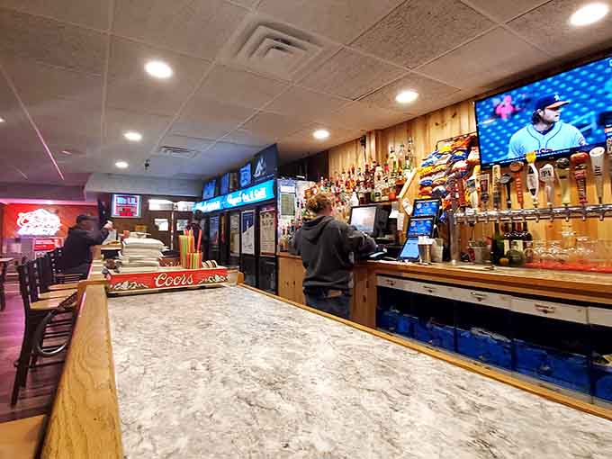 The long bar stretches invitingly with multiple taps and plenty of space for friends to settle in for the evening.