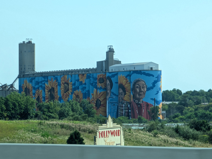 Vibrant sunflowers and meaningful portraits brighten Toledo&rsquo;s skyline&mdash;an inspiring view of the Glass City River Wall from the highway.