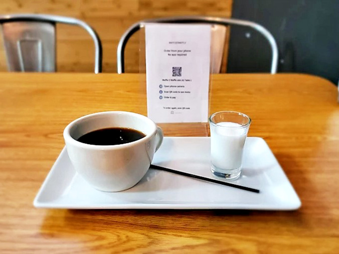 Coffee: The perfect companion to waffle indulgence &ndash; served with a side of cream in a presentation that respects the sacred morning ritual.