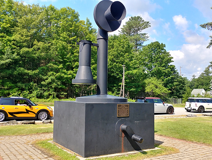 Parked cars provide scale reference for this telecommunications giant, showing just how seriously Bryant Pond takes its telephone history.