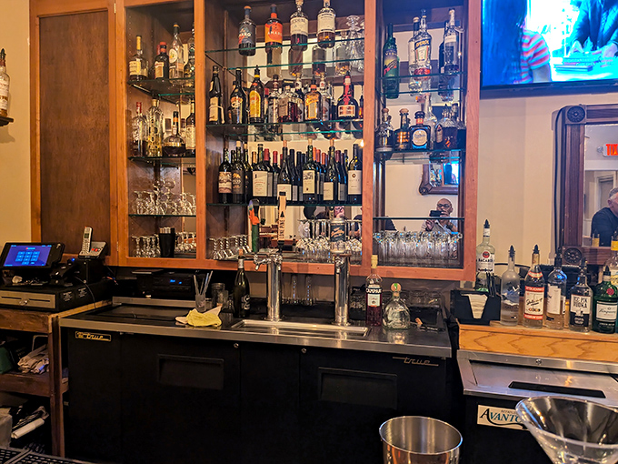 The well-stocked bar gleams with promise, bottles arranged with care by bartenders who take their craft as seriously as the kitchen does.