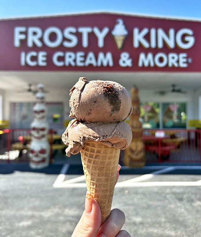 The perfect chocolate cone standing proudly against its birthplace. This isn't just dessert&mdash;it's a monument to simple pleasures done right.