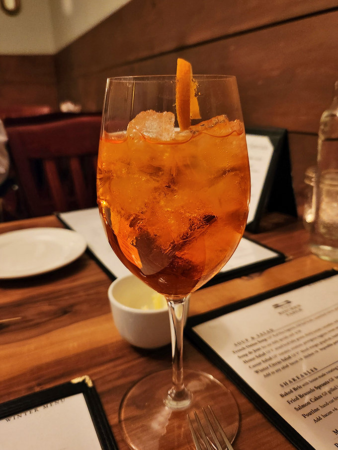 This Aperol Spritz glows like a Vermont sunset in a glass, garnished with an orange slice that's practically winking at you.