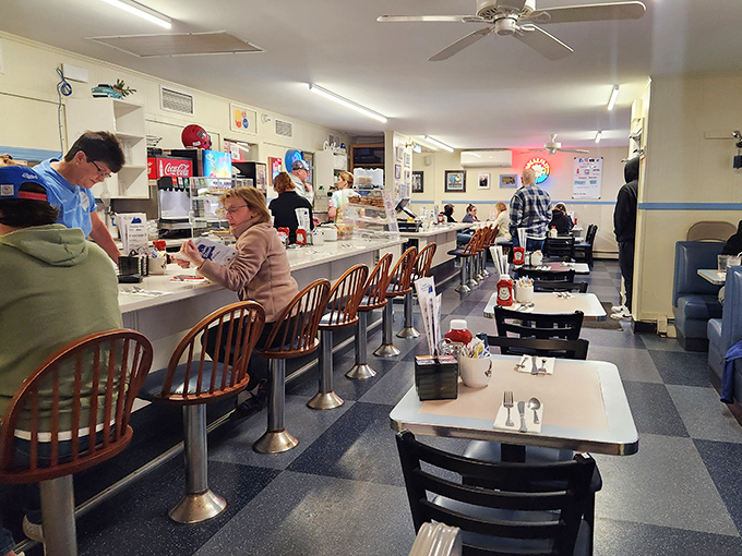 At the counter, where regulars perch on swivel stools, watching the choreographed dance of servers and cooks who've perfected their craft over decades.