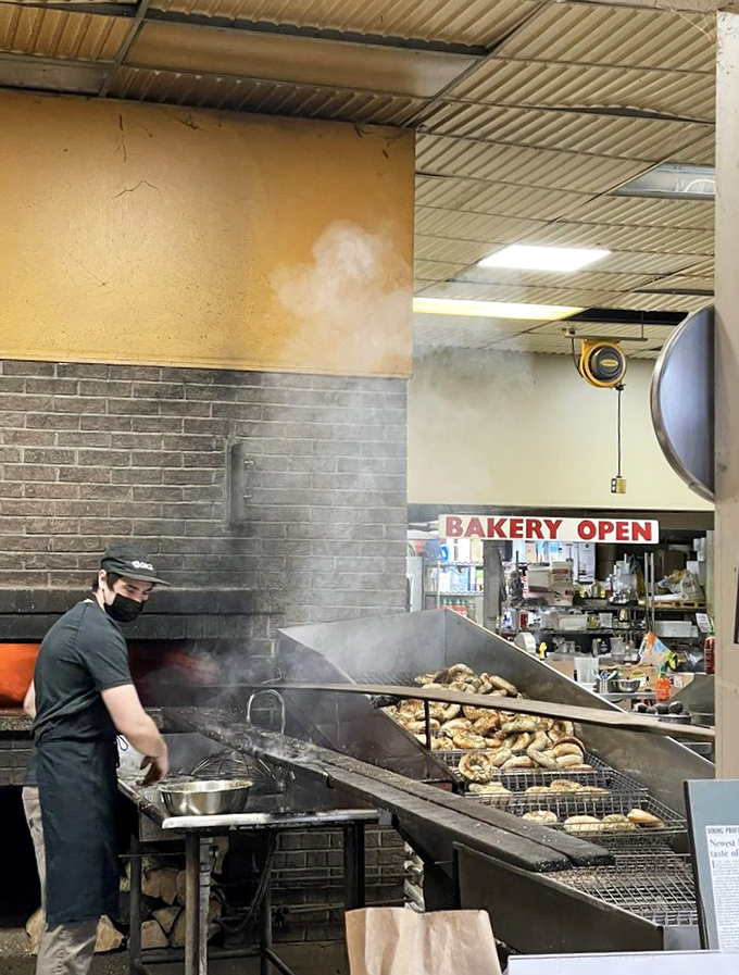 Behind the scenes: the wood-fired oven works its magic as a baker tends to the next batch of hand-rolled treasures.