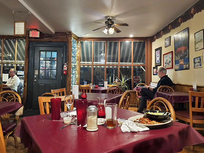 Burgundy tablecloths, wooden chairs, and soft lighting create the perfect setting for the important work of twirling pasta and sharing stories.
