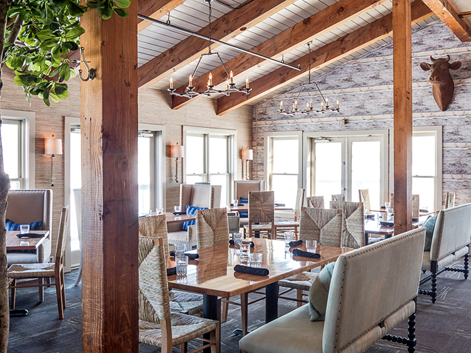 Rustic wooden beams frame a dining space where Maine's nautical heritage meets contemporary comfort&mdash;without a single lobster trap on the wall.