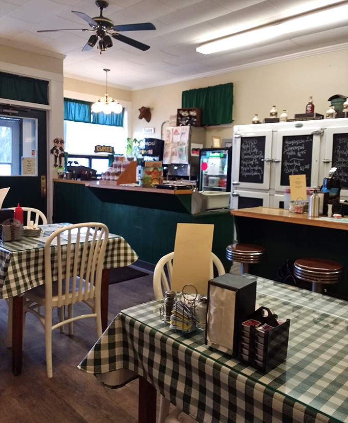 The diner's interior features classic green wainscoting, checkered tablecloths, and an atmosphere of genuine warmth.
