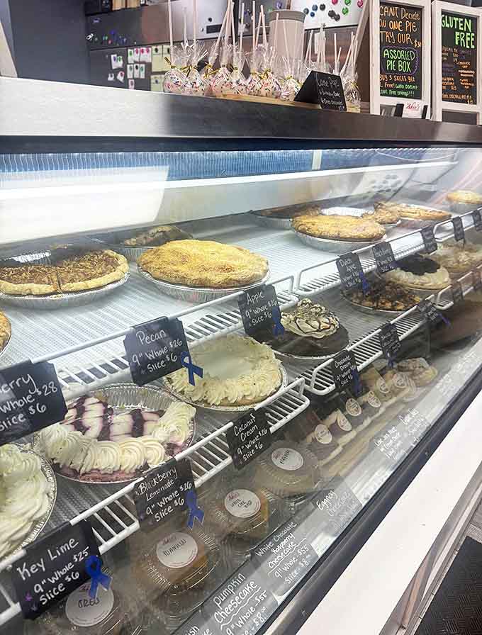 The display case showcases a rainbow of pie possibilities, each one beckoning with flaky crusts and vibrant fillings.