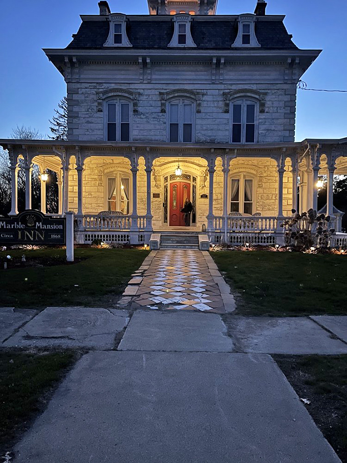 As twilight embraces the mansion, warm lights transform the historic structure into a beacon of hospitality against the evening sky.
