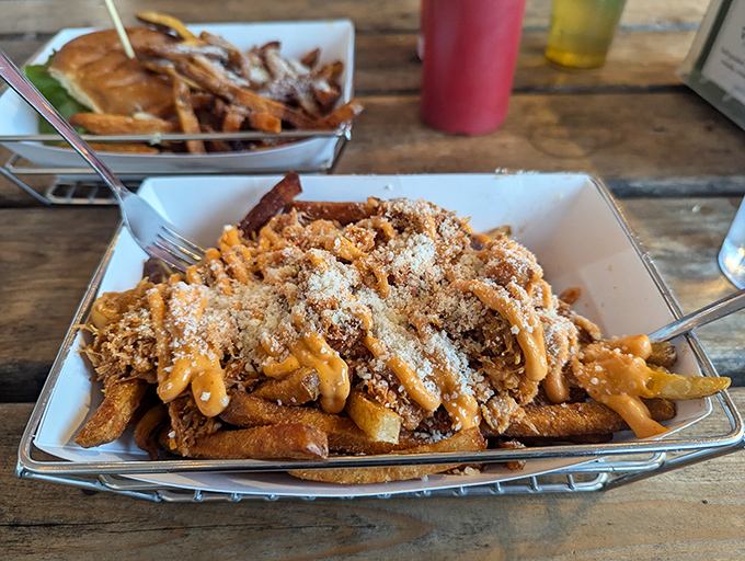 These loaded fries arrive like a beautiful mess &ndash; cheese sauce cascading through golden potatoes, creating the kind of indulgence that requires no apology.