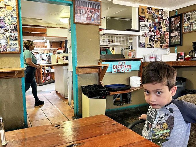 Rustic charm defines the dining area, where wooden walls and simple furnishings create the perfect backdrop for memorable meals and conversations.