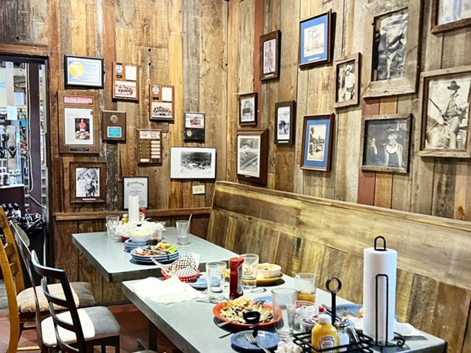 Rustic wood-paneled walls lined with historical photographs create the perfect backdrop for memorable meals with friends and family.