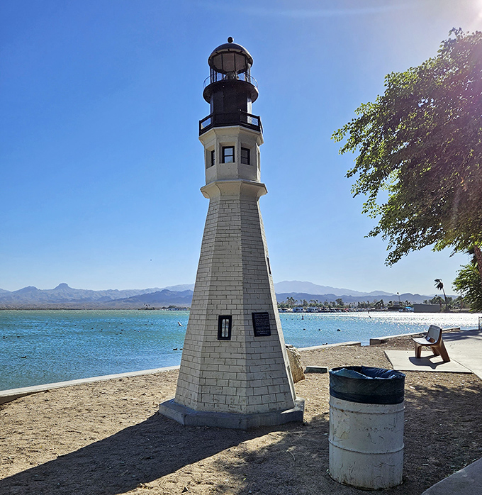 The lighthouse stands as a whimsical guardian of the lake, a maritime tradition transplanted to desert shores.
