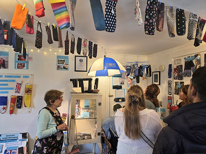 Visitors listen intently during a guided tour, discovering the surprising cultural significance behind these often-discarded textile tubes.