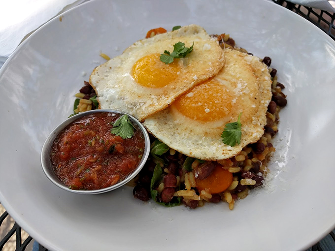 A hearty breakfast bowl topped with sunny-side-up eggs and salsa &ndash; morning fuel that makes you actually look forward to waking up.
