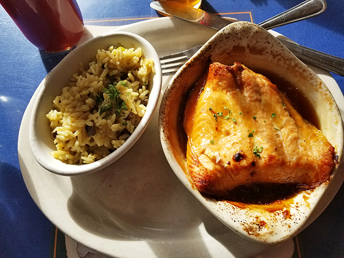 The maple salmon rests in its glaze like it's taking a luxurious bath, the caramelized edges promising a perfect sweet-savory balance in every bite.